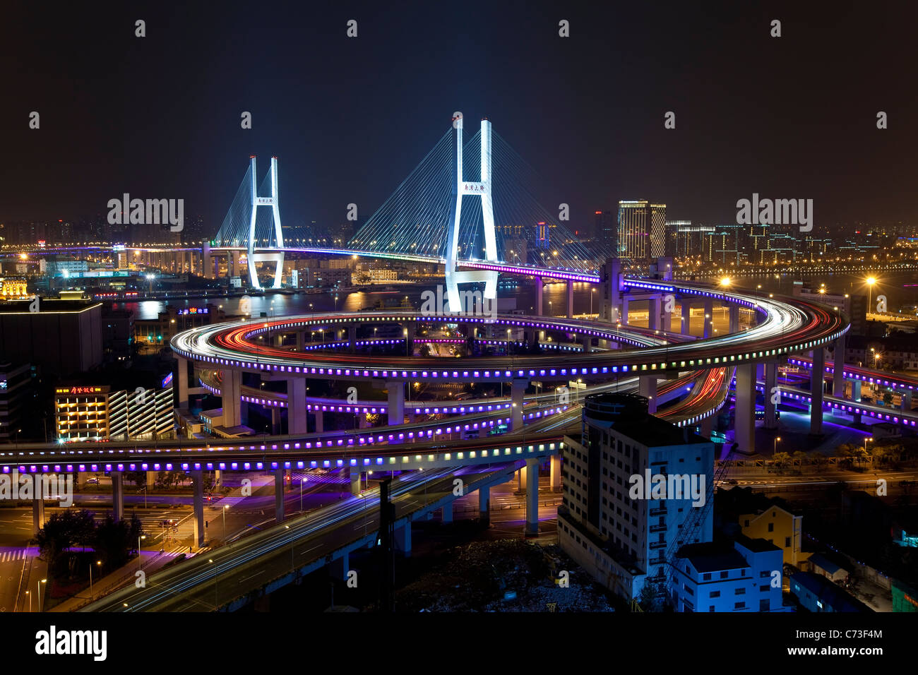 High angle wide shot traffic on Nanpu Bridge spiral, illuminated Bridge ...