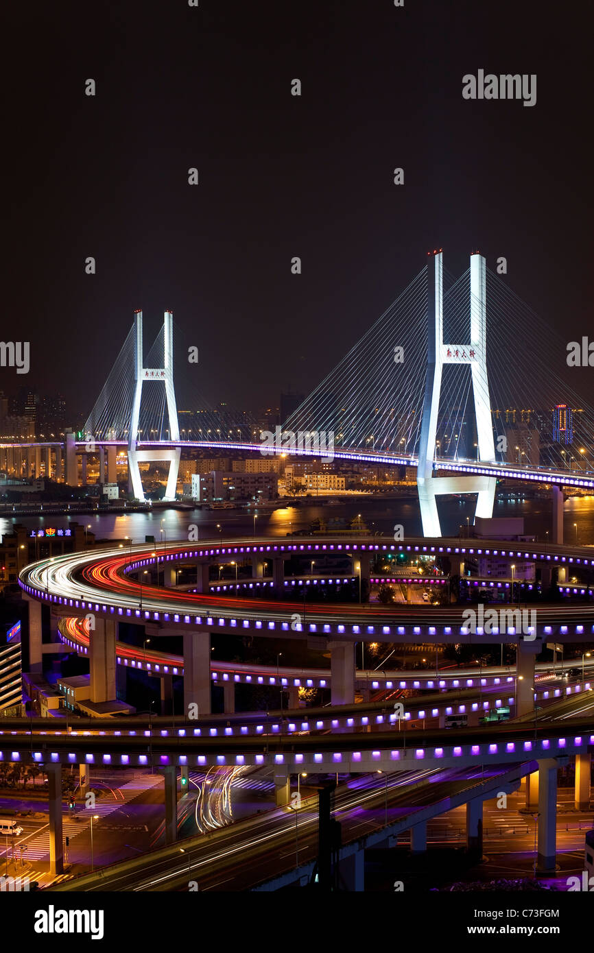 High angle wide shot traffic on Nanpu Bridge spiral, illuminated Bridge ...