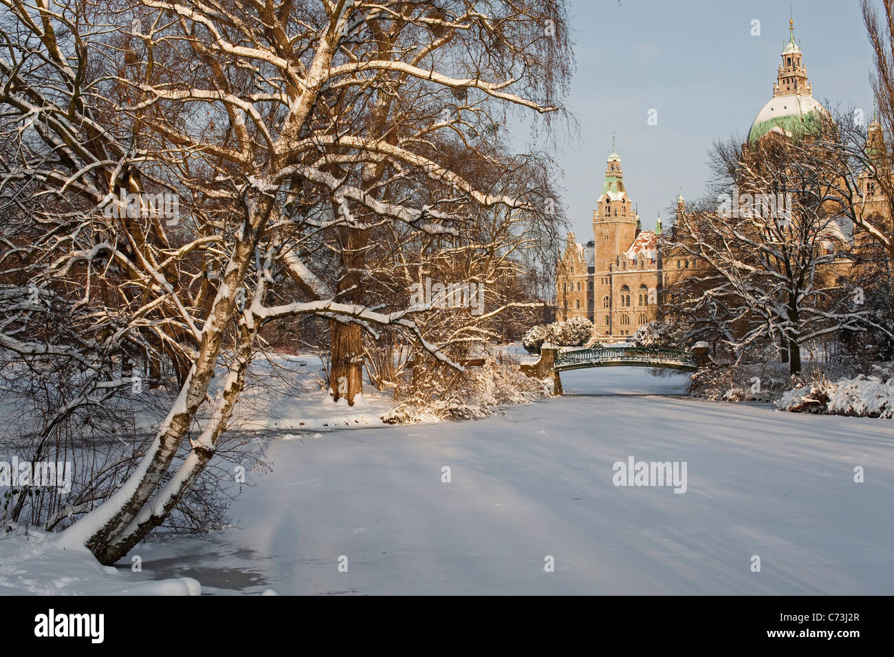 Masch park in Winter, bridge with frozen pond, New Town Hall in the ...