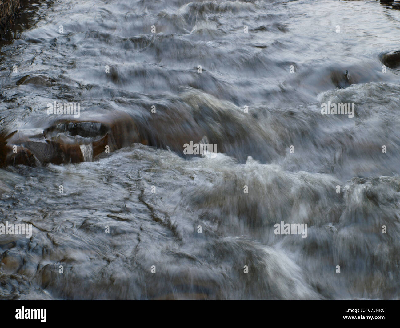 Fastflowing river over riverbed rocks Stock Photo - Alamy
