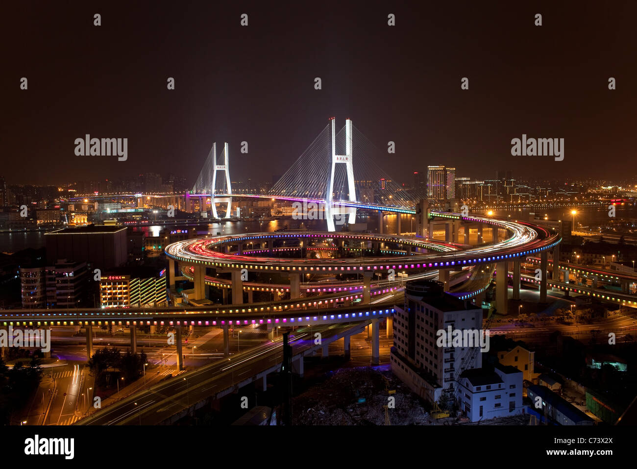 High angle wide shot traffic on Nanpu Bridge spiral, illuminated Bridge ...