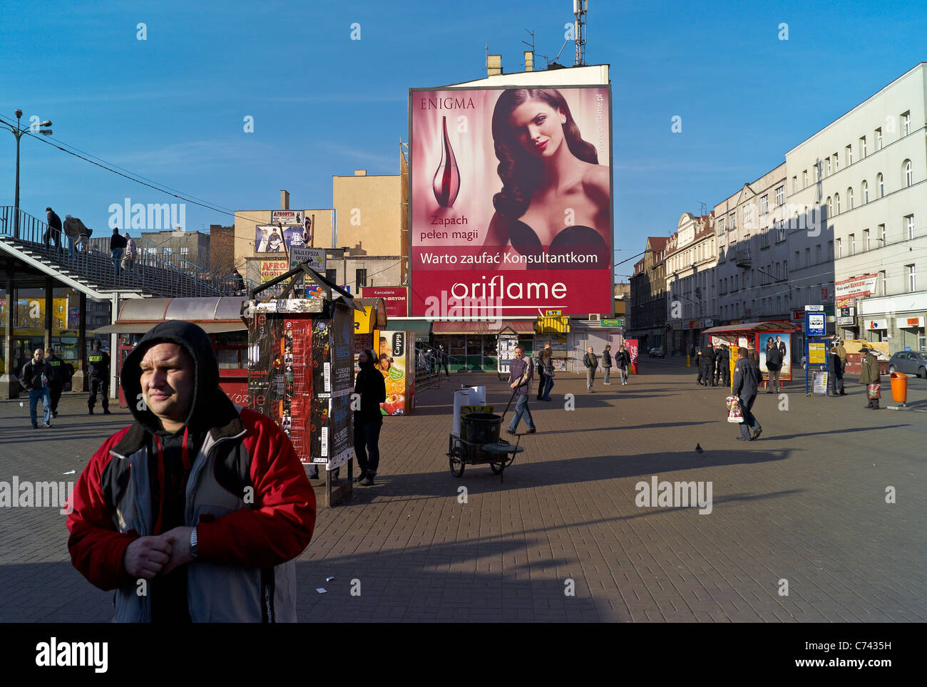 A large billboard for perfumes and pedestrians in the city centre ...