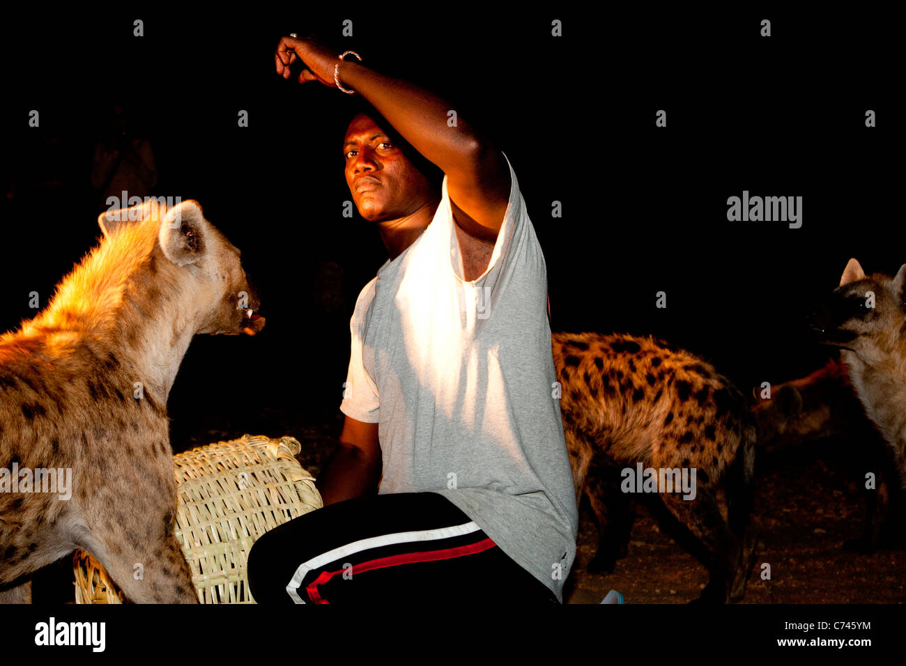 The Hyena-Man feeding hyenas near Sanga Gate just outside the city ...