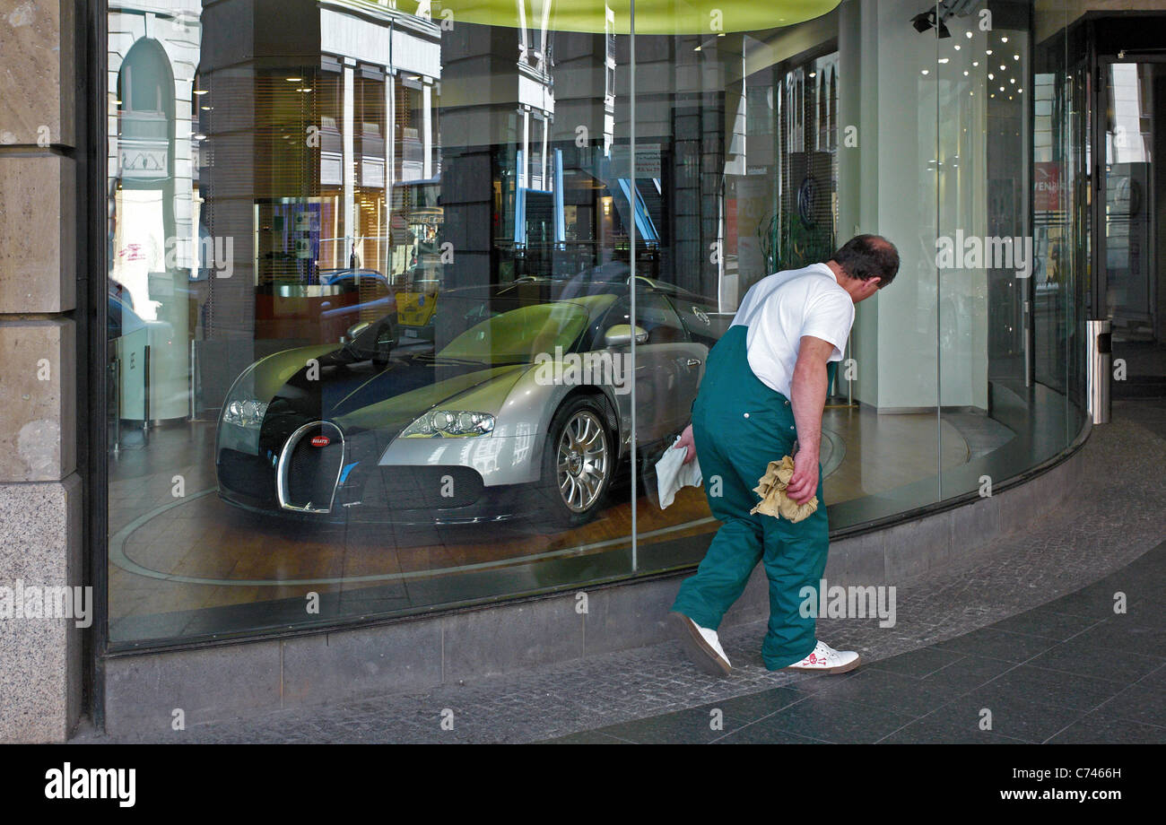A man cleaning the windows of a car dealership Berlin Germany Stock ...