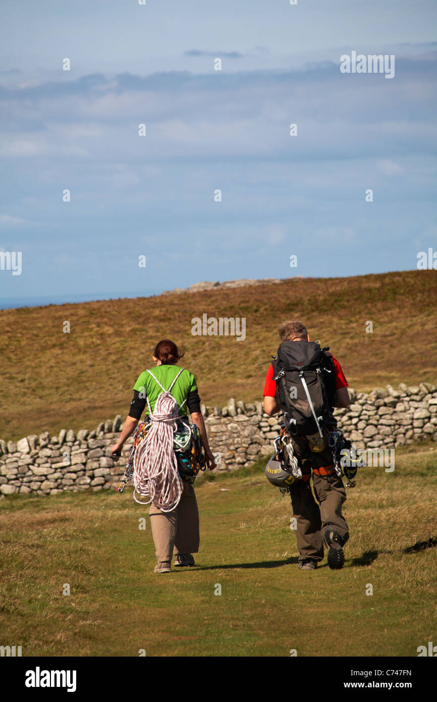 Rock climbers walking with their equipment to do some rock climbing at ...