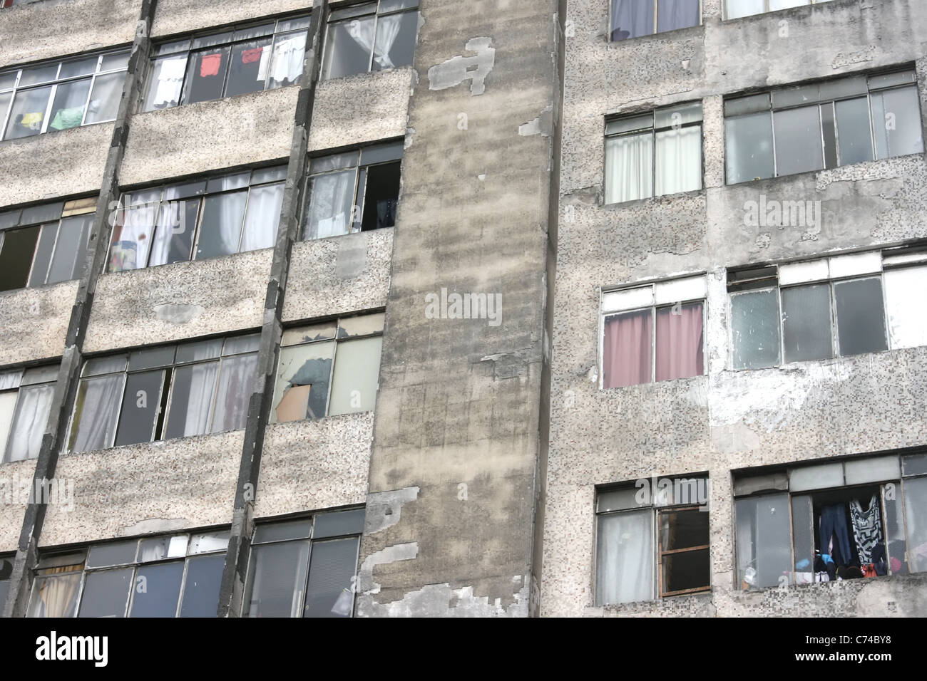 Facade of a rundown building in a poor neighborhood in the center of ...