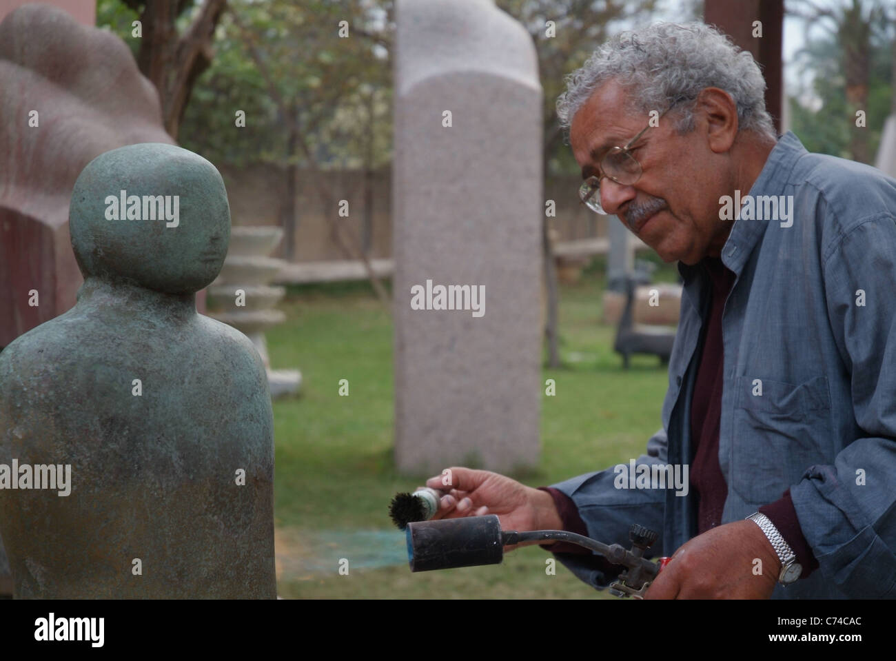 Haraniyya, Egypt -- Jan 2006 -- Egyptian sculptor Adam Henein at work ...
