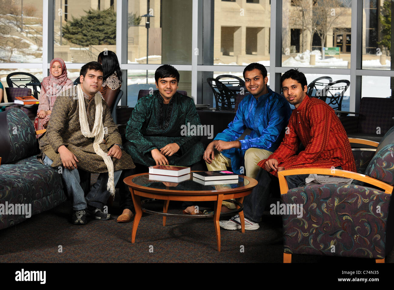Group of ethnic students seated at student hall Stock Photo - Alamy