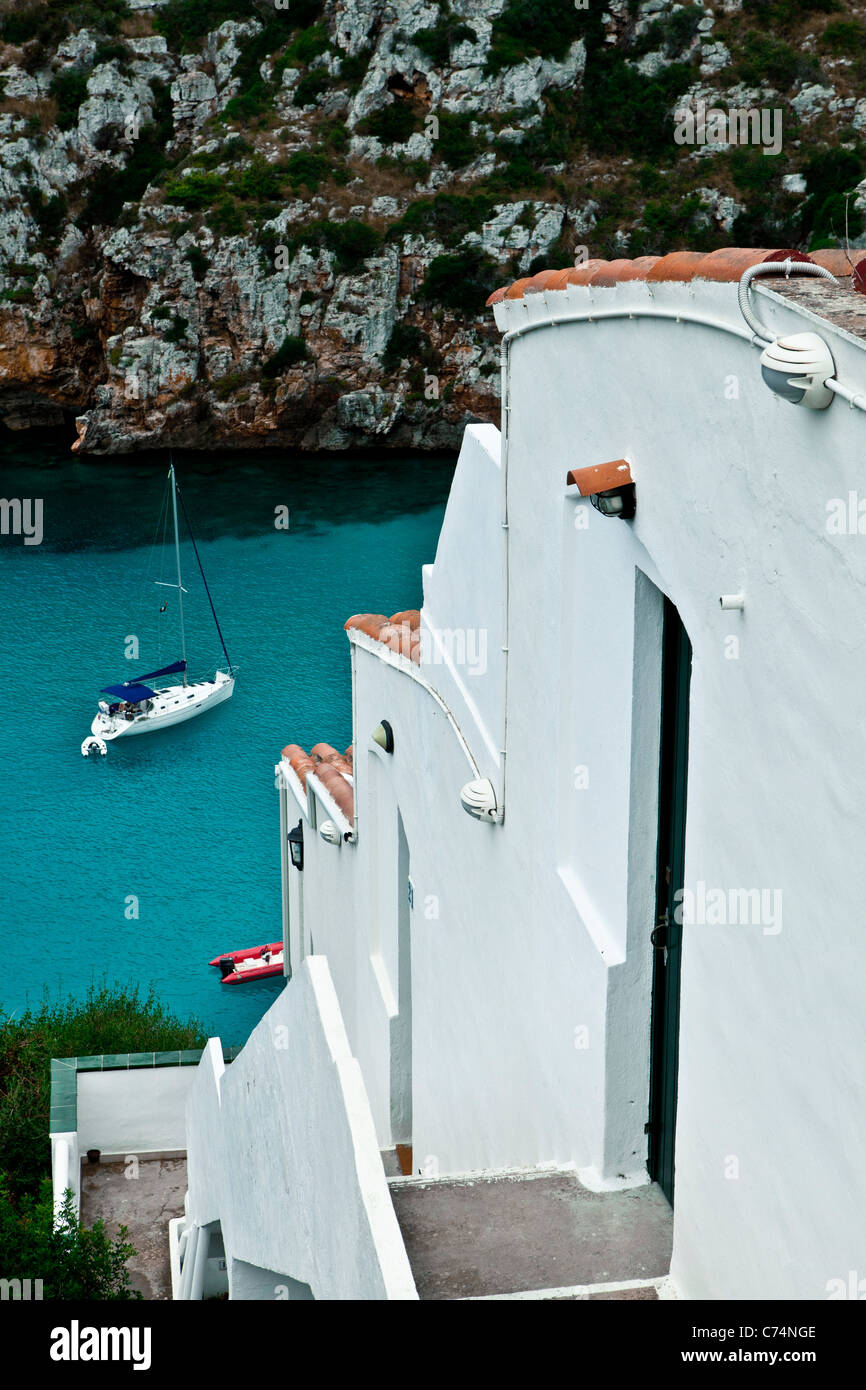 White house on cliff above Cala En Porter bay, Menorca Stock Photo - Alamy