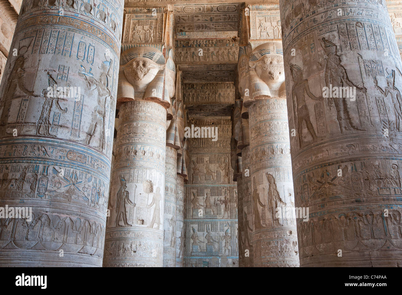 Columns inside an ancient egyptian temple covered in hieroglyphic ...