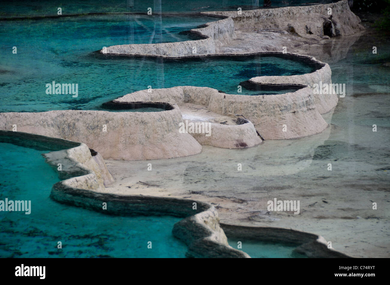 Beautifully curved outlines of travertine terrace and blue water pools ...