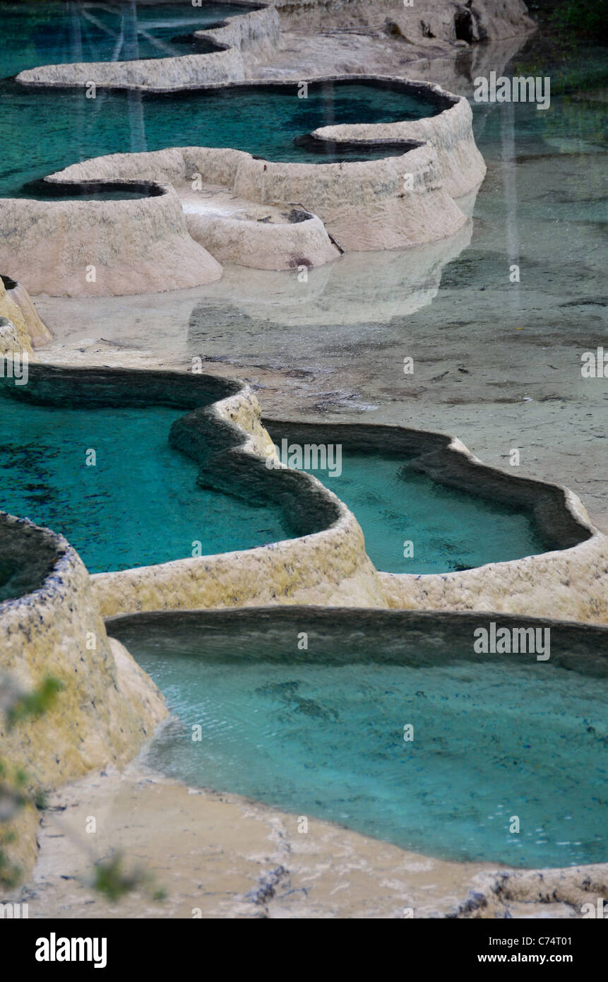 Beautifully curved outlines of travertine terrace and blue water pools ...