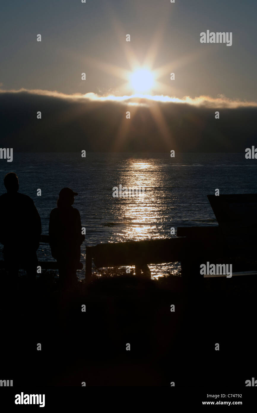 Woman watching sunset over ocean hi-res stock photography and images ...