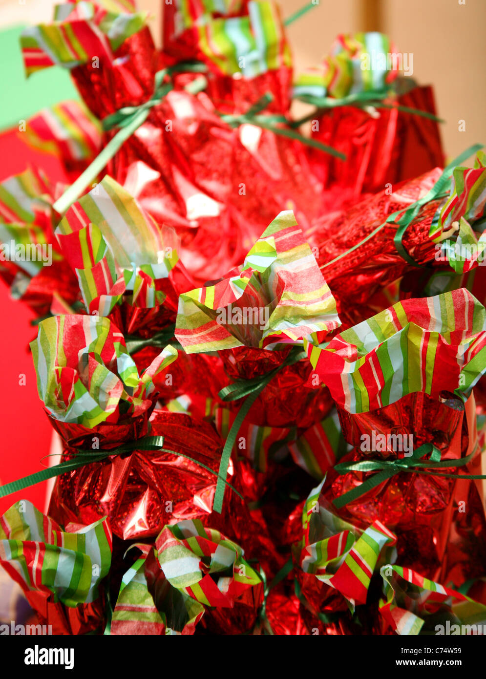 Stack of multiple similar christmas presents on bags of multiple colors ...