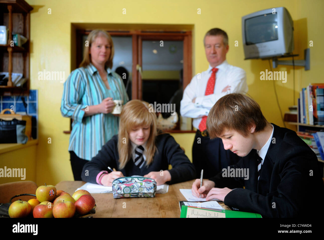 Parents watch as school children do their homework UK Stock Photo - Alamy