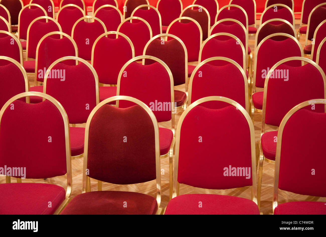 Red and golden chairs in rows Stock Photo - Alamy