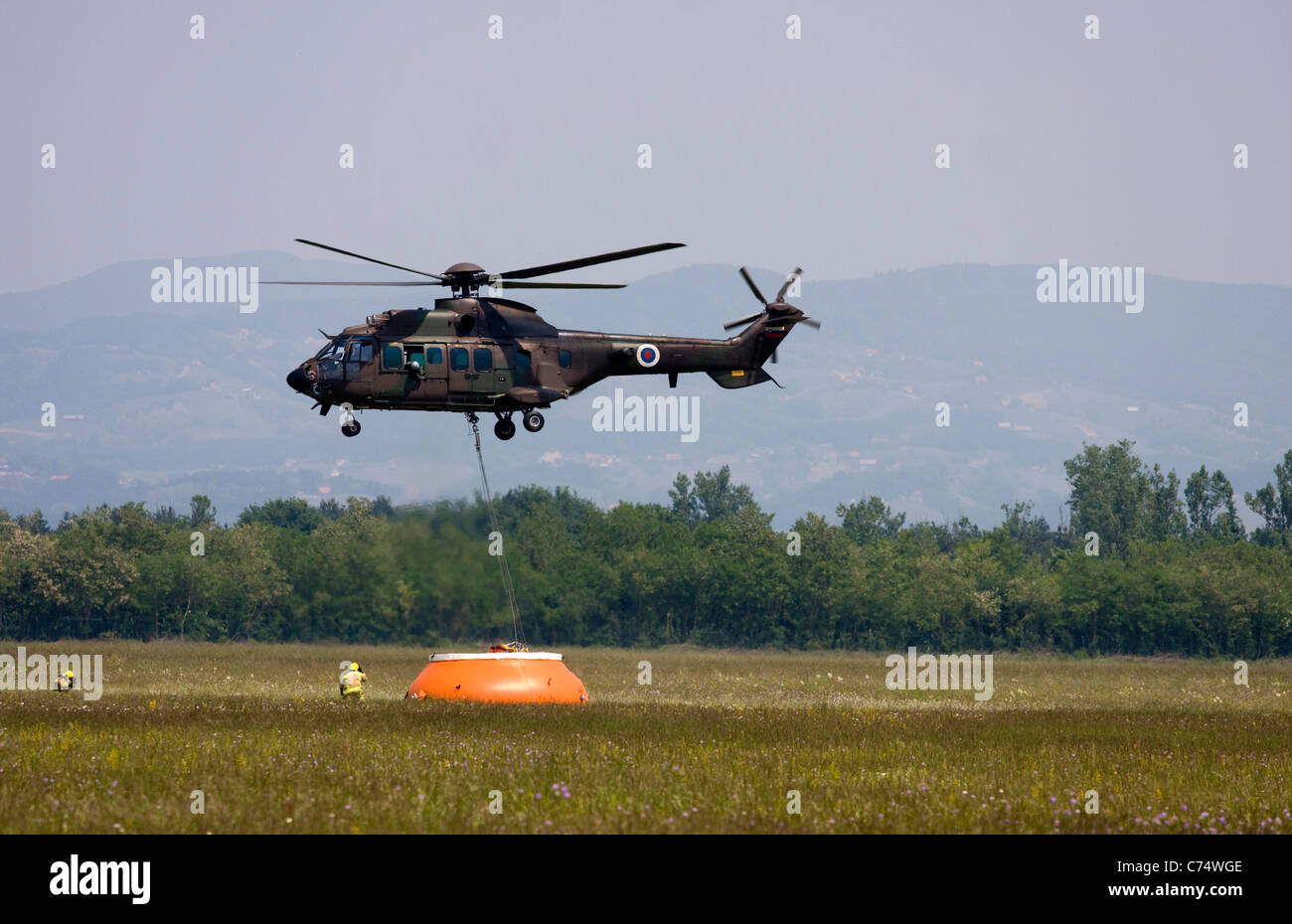 Helicopter floating and picking up water Stock Photo - Alamy