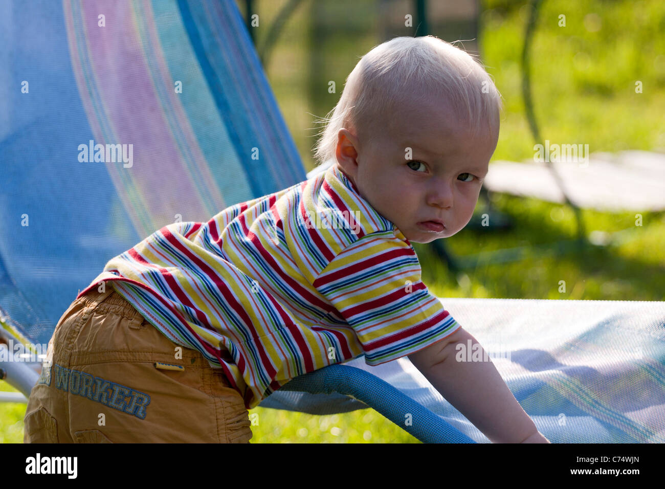 Little toddler having fun in the back-yard Stock Photo - Alamy