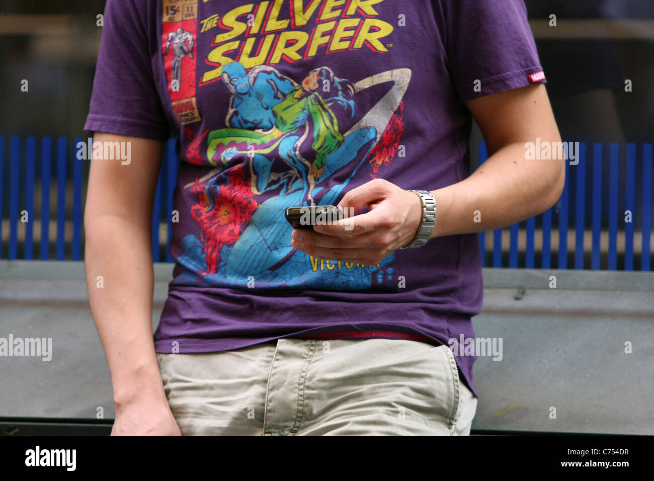 a young man using a mobile phone in a street Stock Photo - Alamy