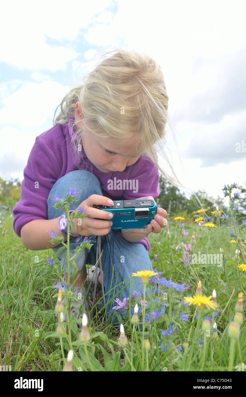 KIds enjoying taking photographs of bug and animals in a field Stock ...