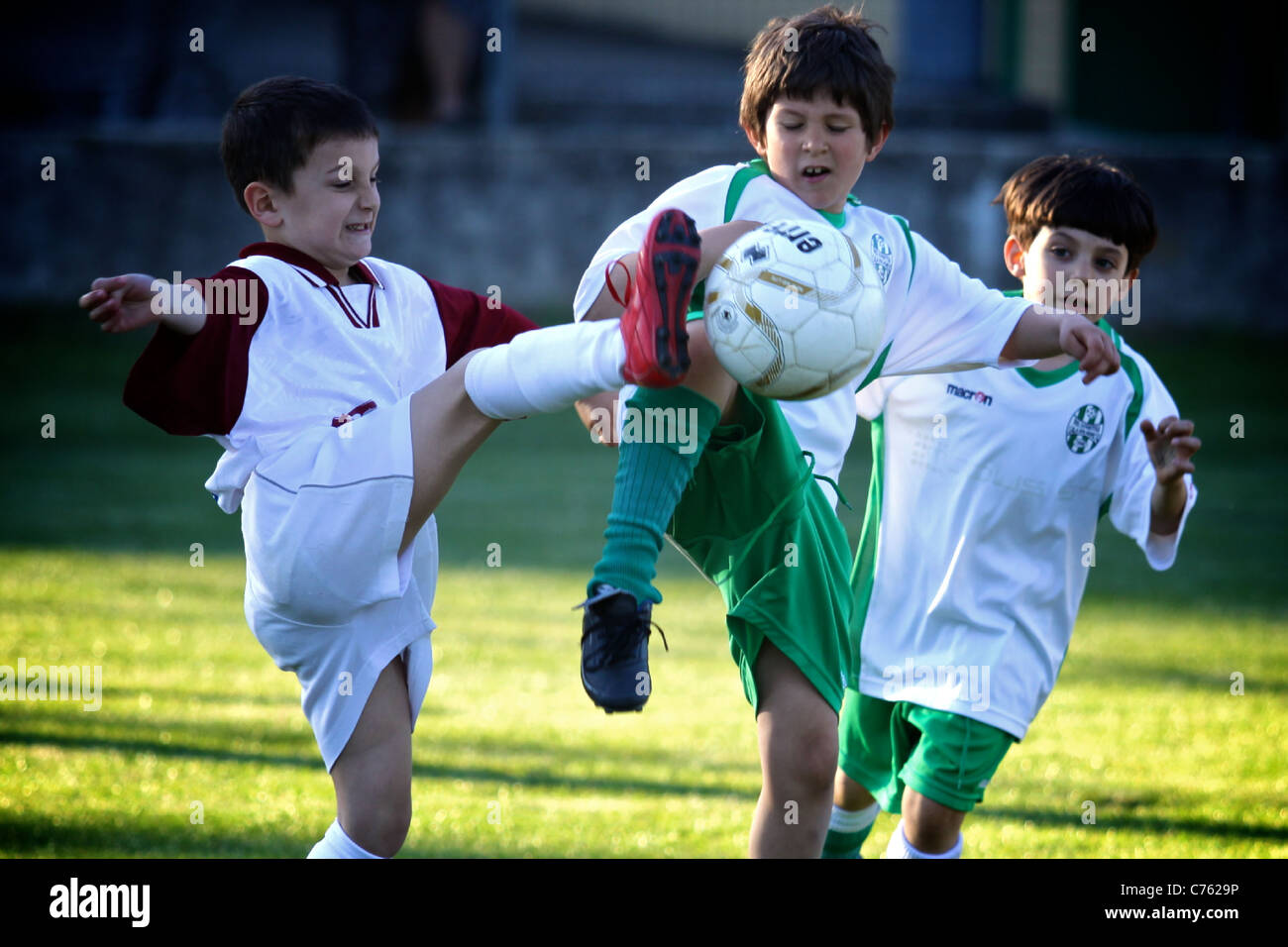air confrontation between kid soccer players to catch the ball Stock ...