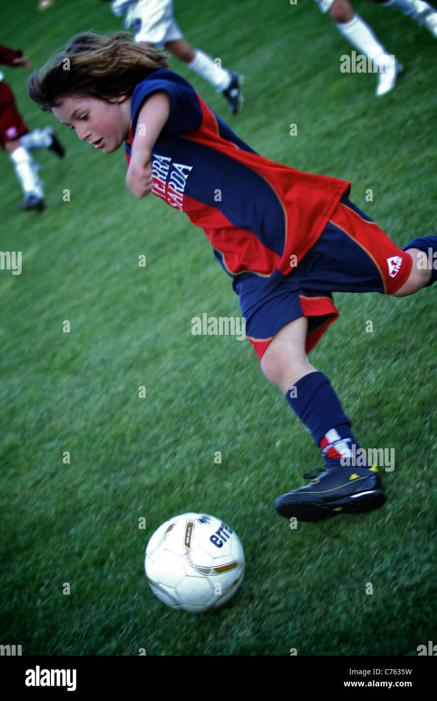 solo running, a striker kid is going to kick to goal Stock Photo - Alamy