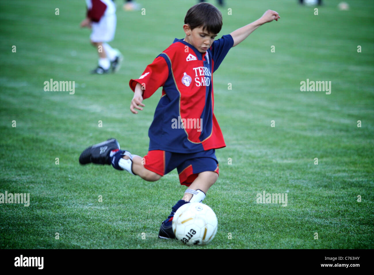 kick to goal! kid soccer player is near to score Stock Photo - Alamy