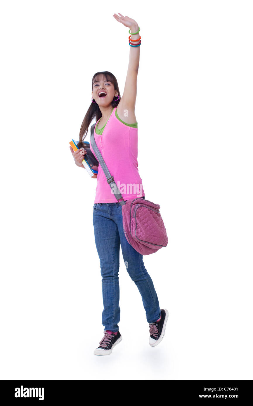 Full length of pretty young college girl waving over white background ...