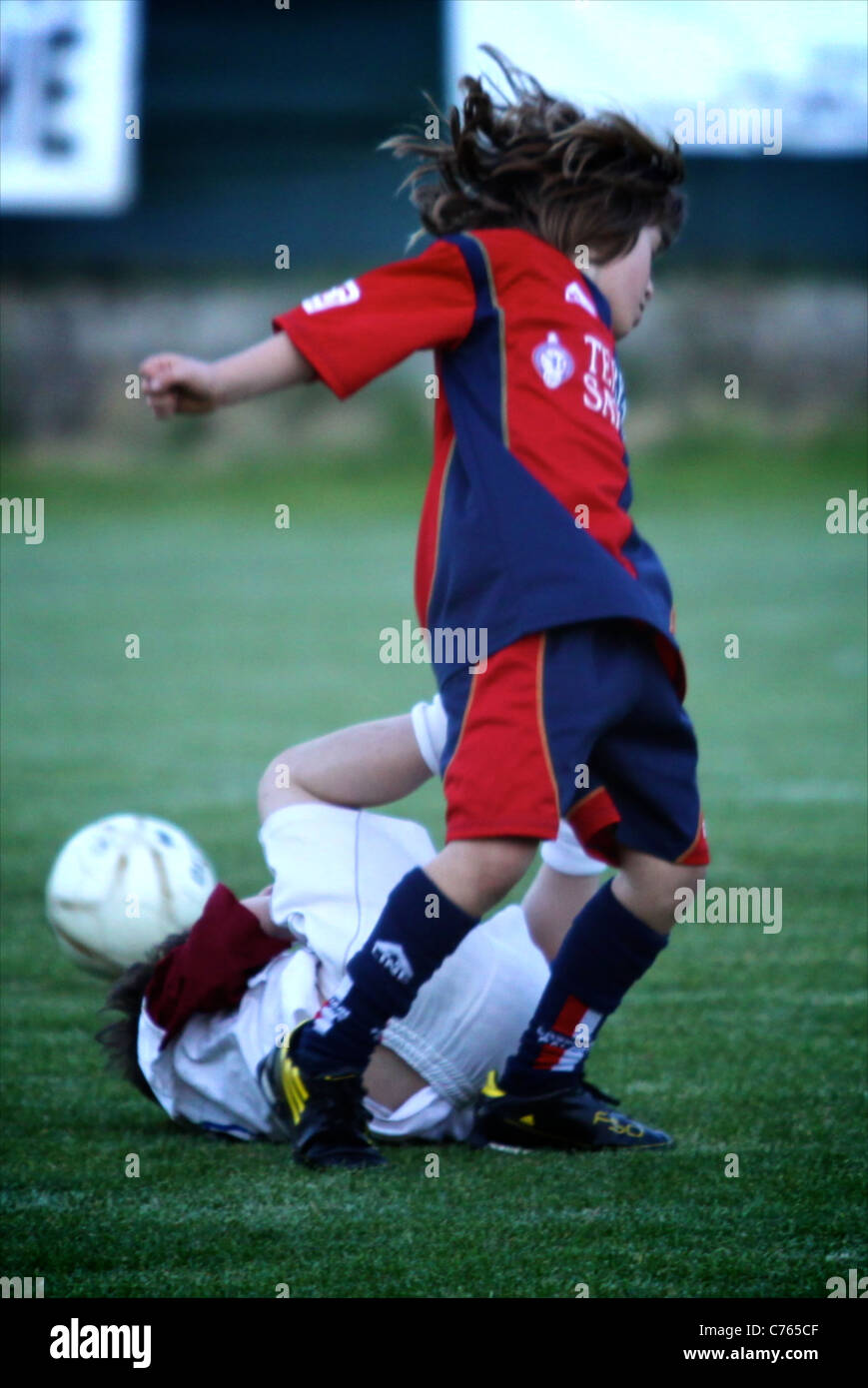 confrontation between players, one on the floor and the other trying to ...