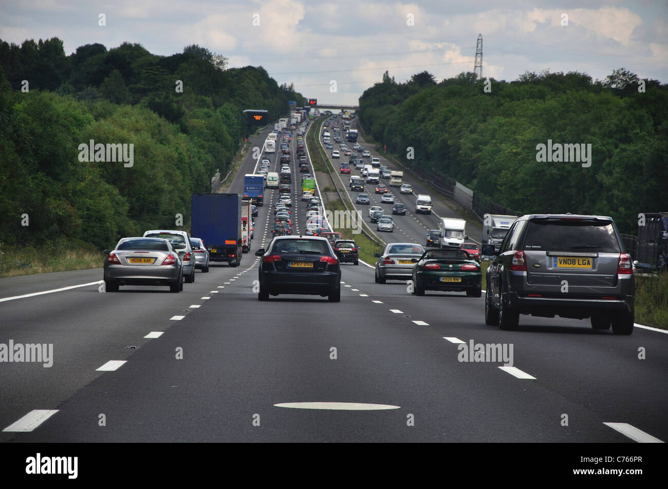 A busy motorway scene with rows of cars and lorries UK Stock Photo - Alamy