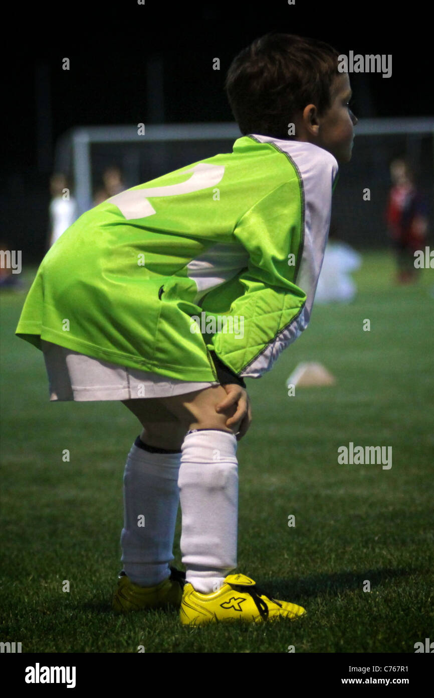 goalkeeper waiting for the ball, looking forward resting on the knees ...