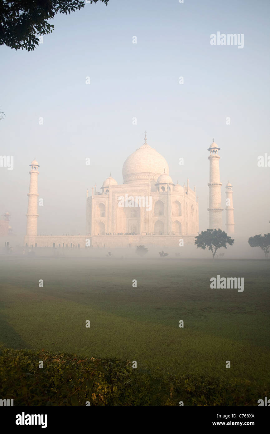The Taj Mahal seen rosy pink through an early morning fog at Agra ...