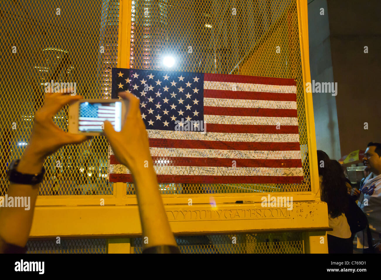A woman photographs a memorial on the tenth anniversary of the ...