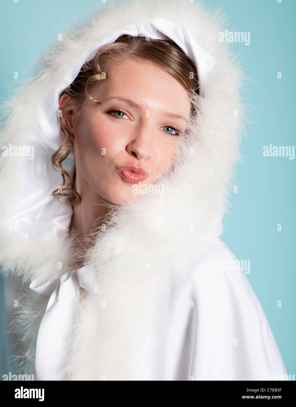 Portrait of happy bride wearing fur hood and puckering lips Stock Photo ...