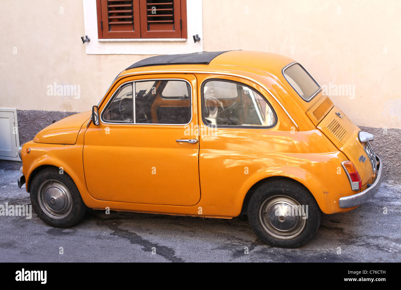 A yellow Fiat 500 in a back street in Taormina, Sicily. Picture by ...