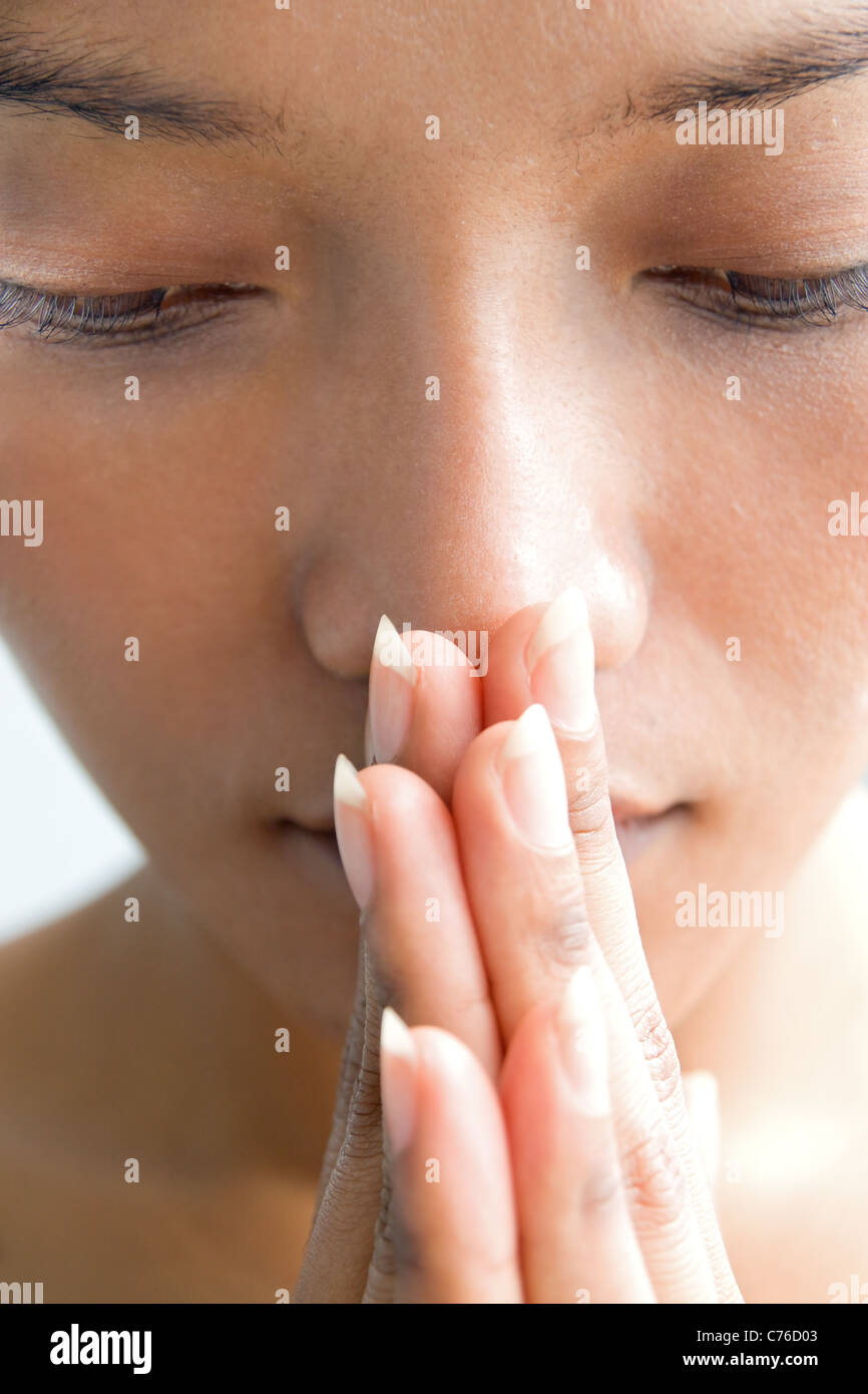 Closeup portrait of a young woman praying Stock Photo - Alamy