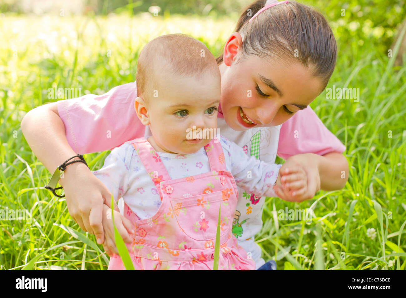 help to walking a baby girl Stock Photo - Alamy