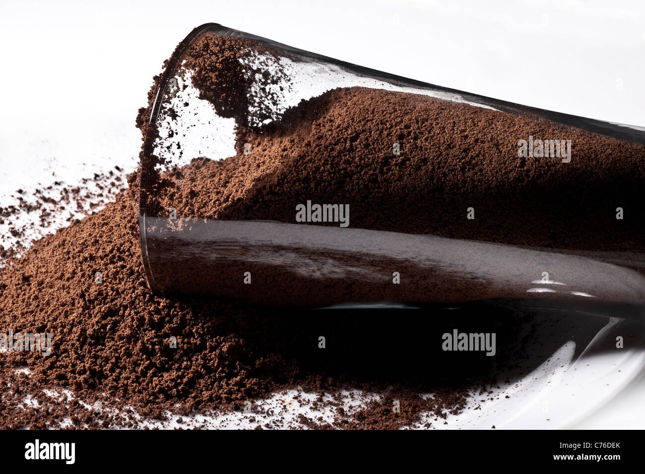 Glass spilling ground coffee Stock Photo - Alamy