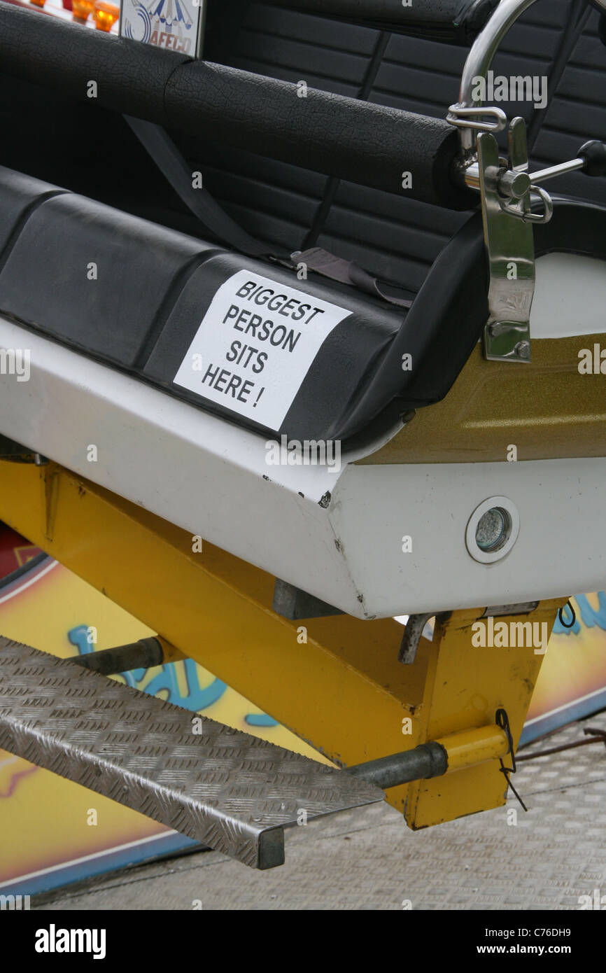 fair ground ride with safety message sign notice Stock Photo - Alamy