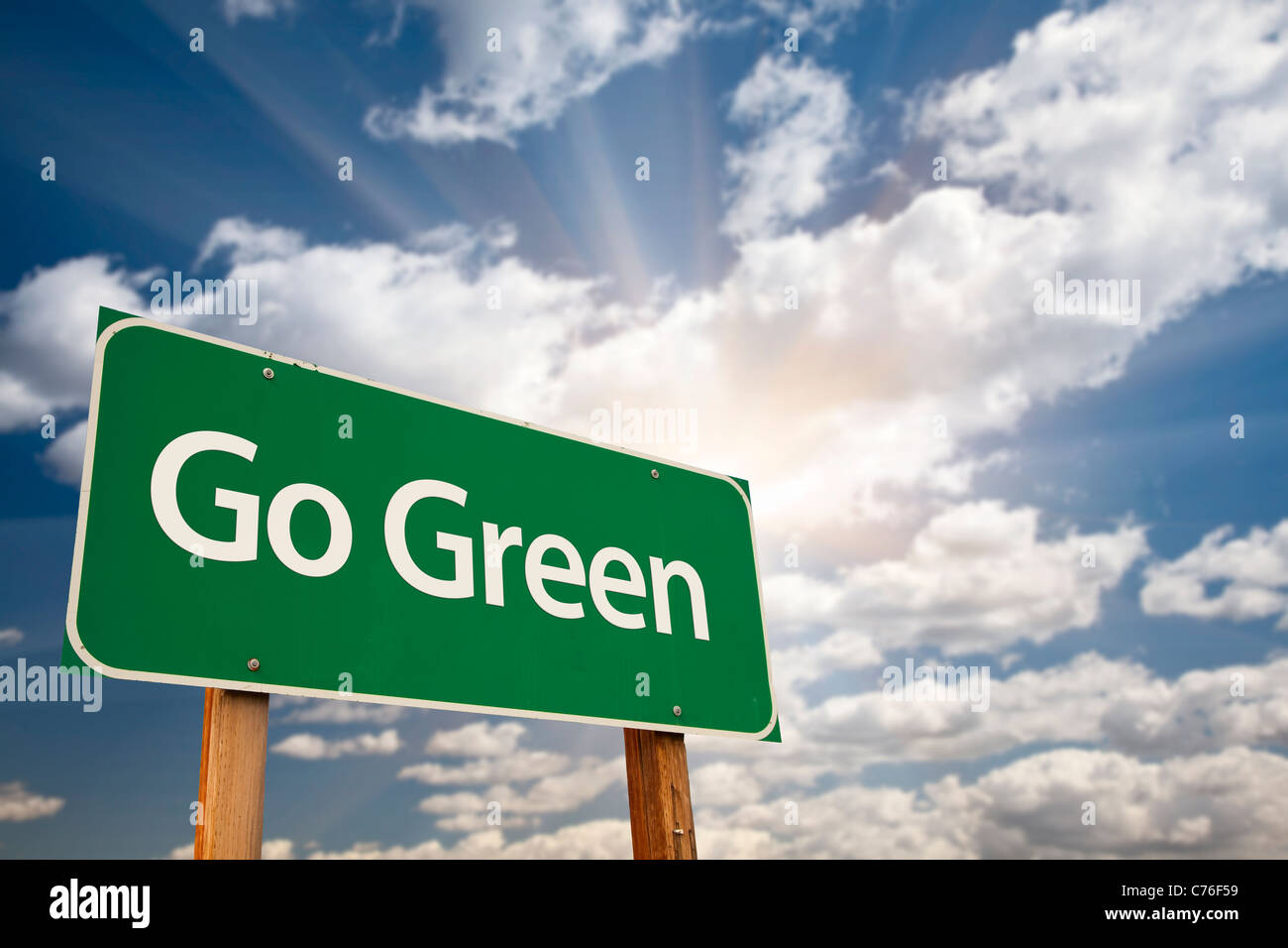 Go Green Road Sign Against Dramatic Clouds, Sky and Sun Rays Stock Photo - Alamy