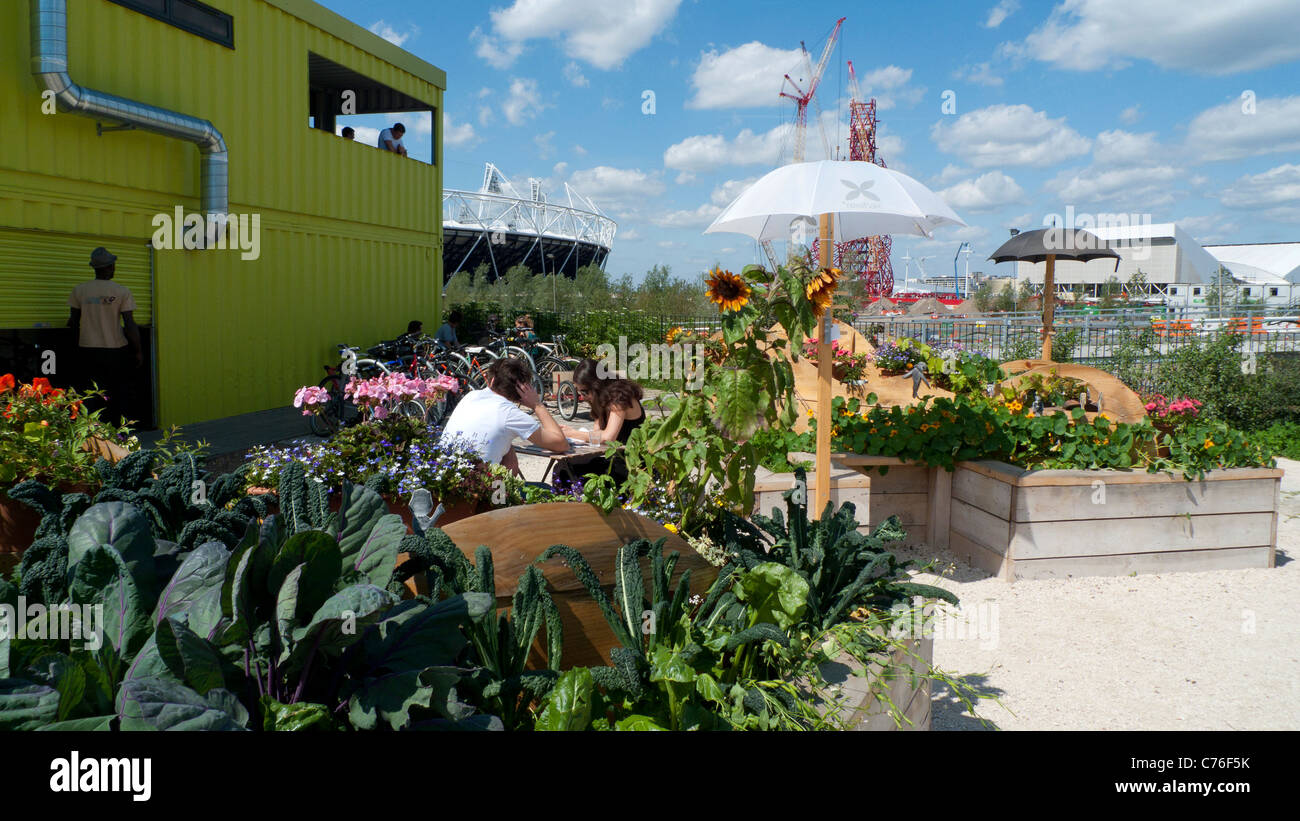 A couple sitting eating at outdoor cafe at the View Tube area with a ...