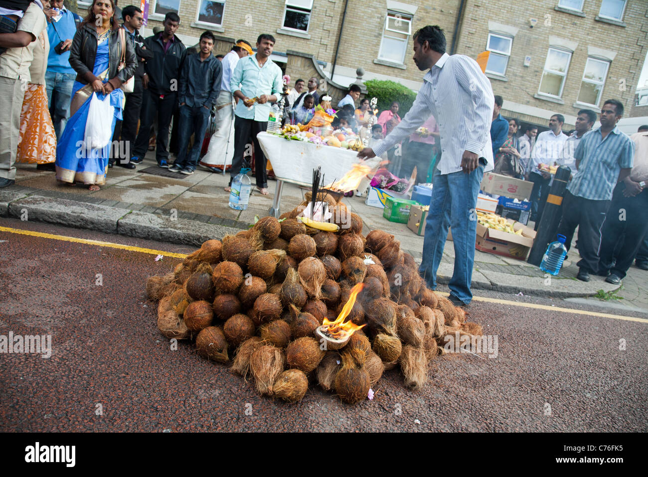 Smashing coconuts on the road, Thaipusam procession, during the Annual ...