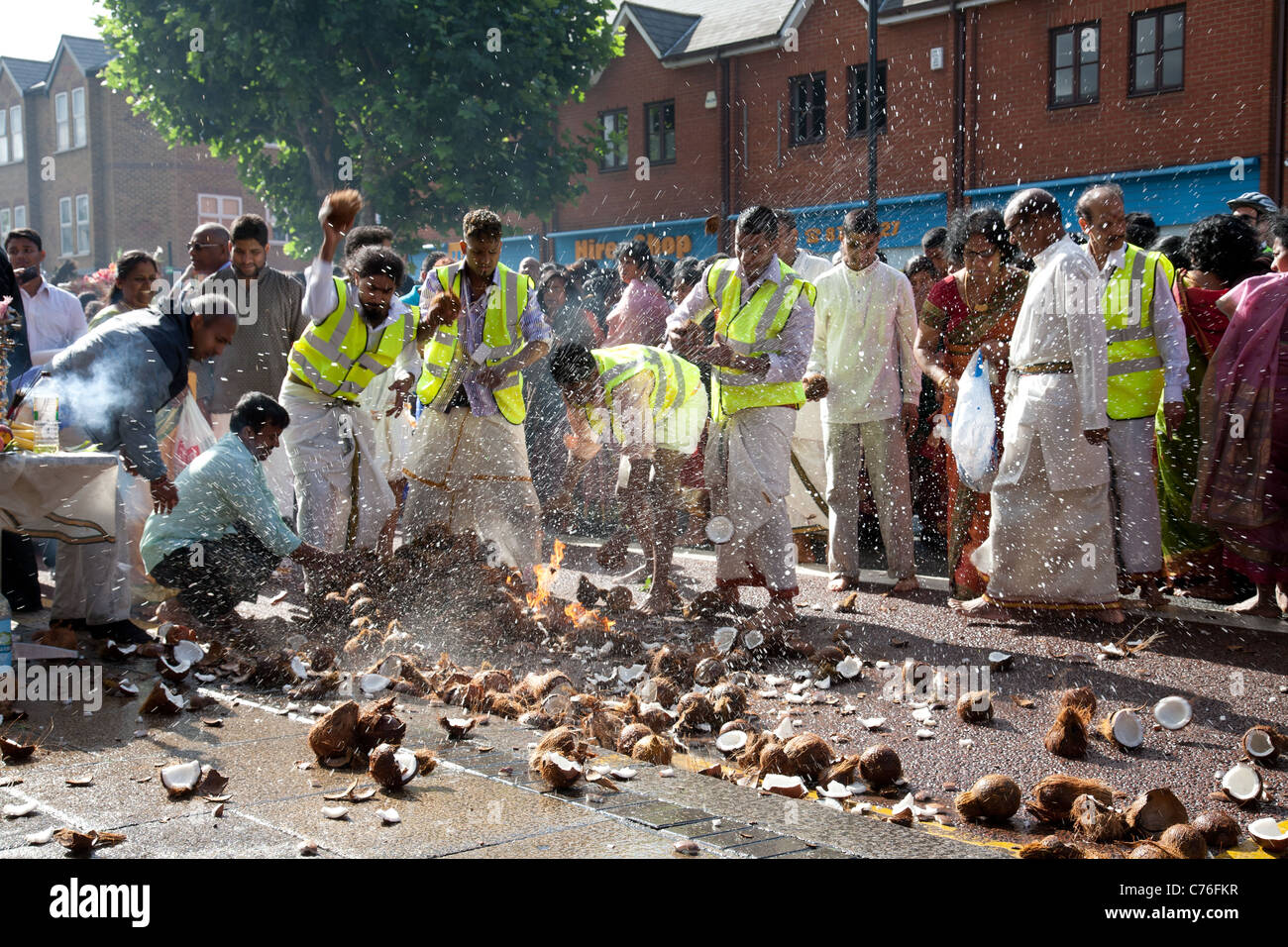 Smashing coconuts on the road, Thaipusam procession, during the Annual ...