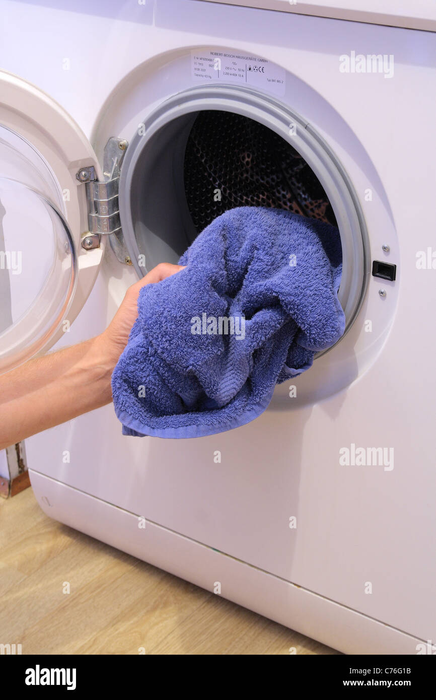 Caucasian Adult Male Loading or Unloading an Electric Bosch Washing ...