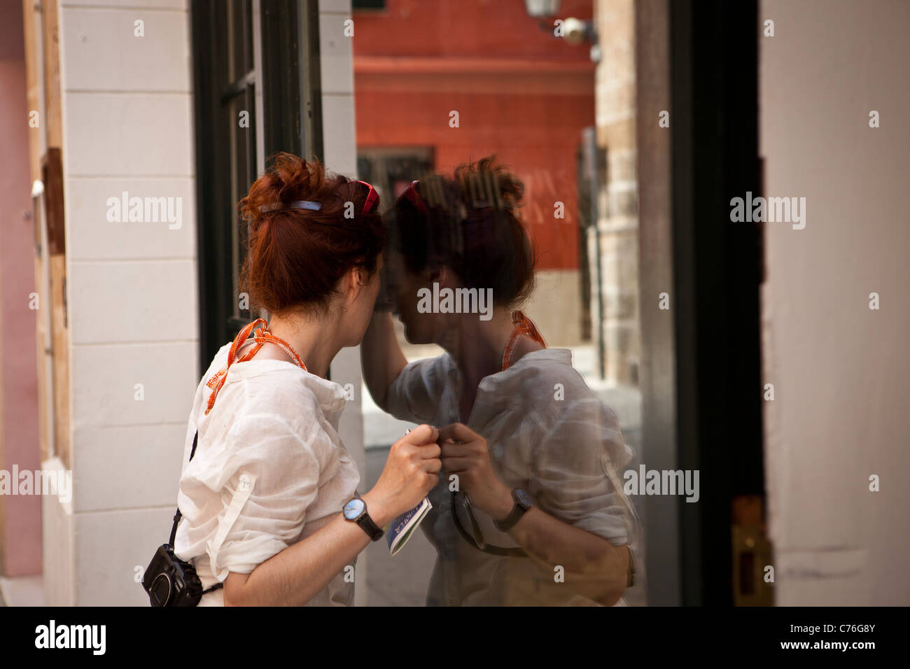 Woman window shopping Stock Photo - Alamy