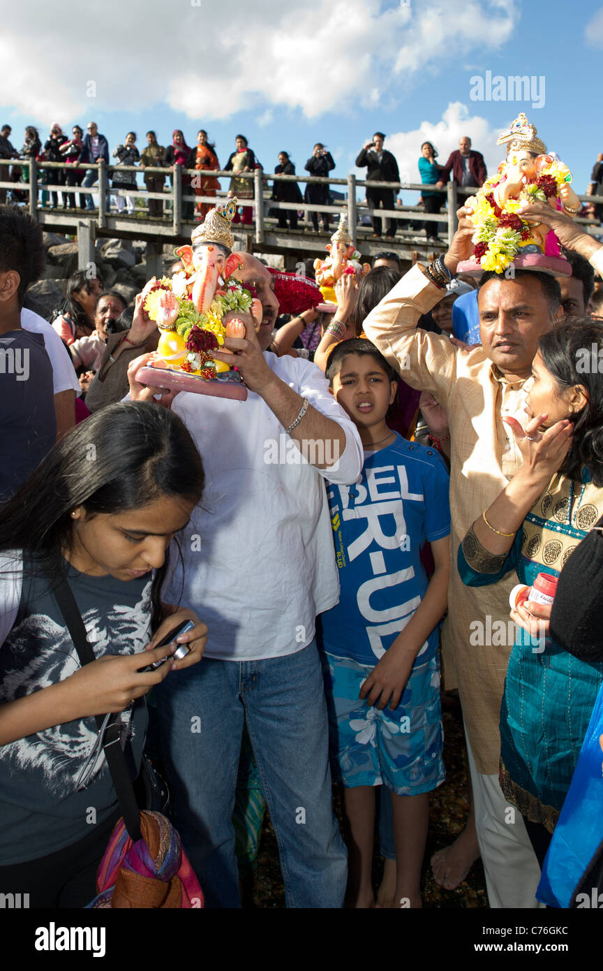 Hindu followers taking part in a blessing at the annual Ganesh festival ...