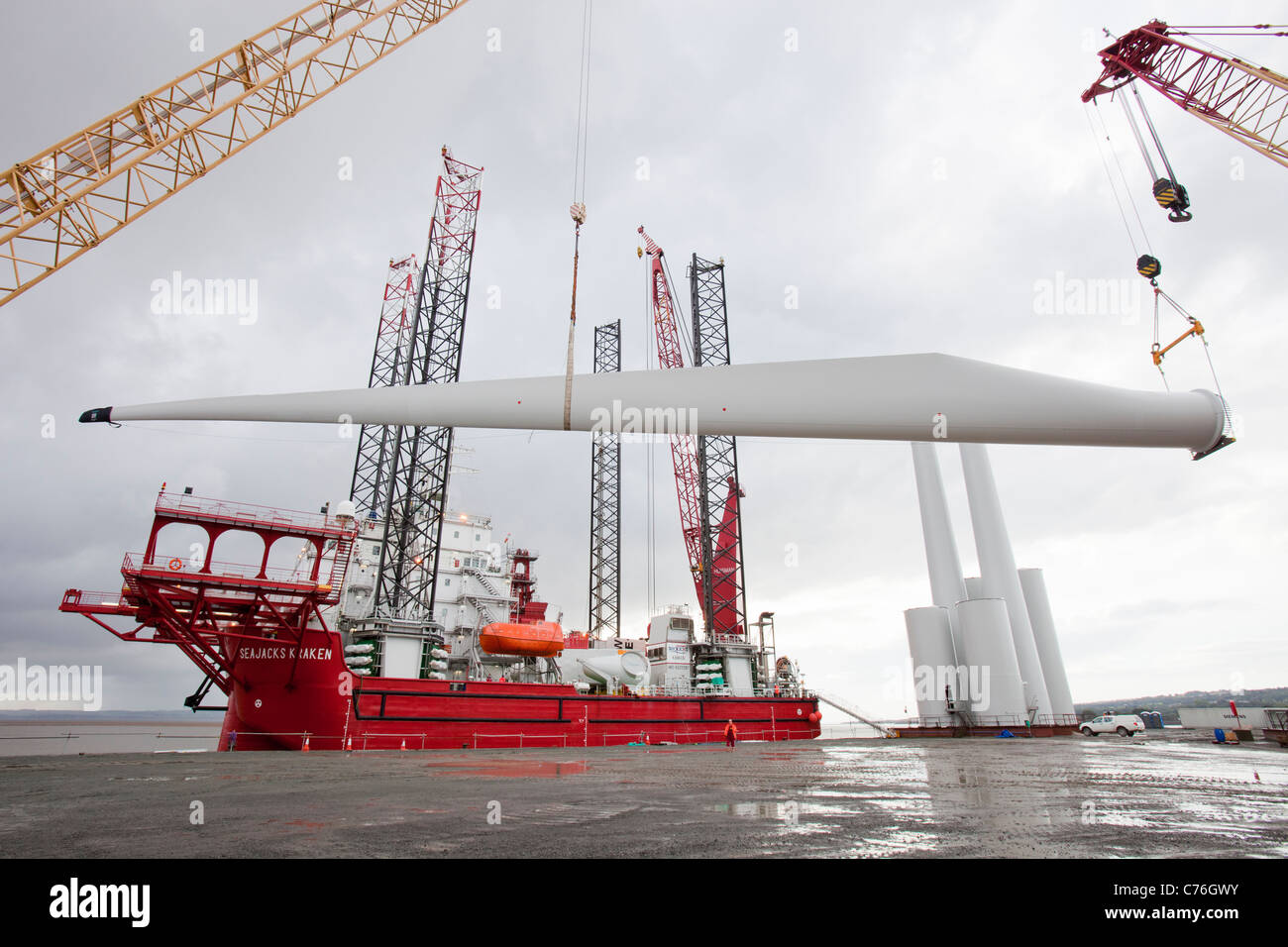 wind turbine blades being lifted onto a jack up barge, to construct the ...