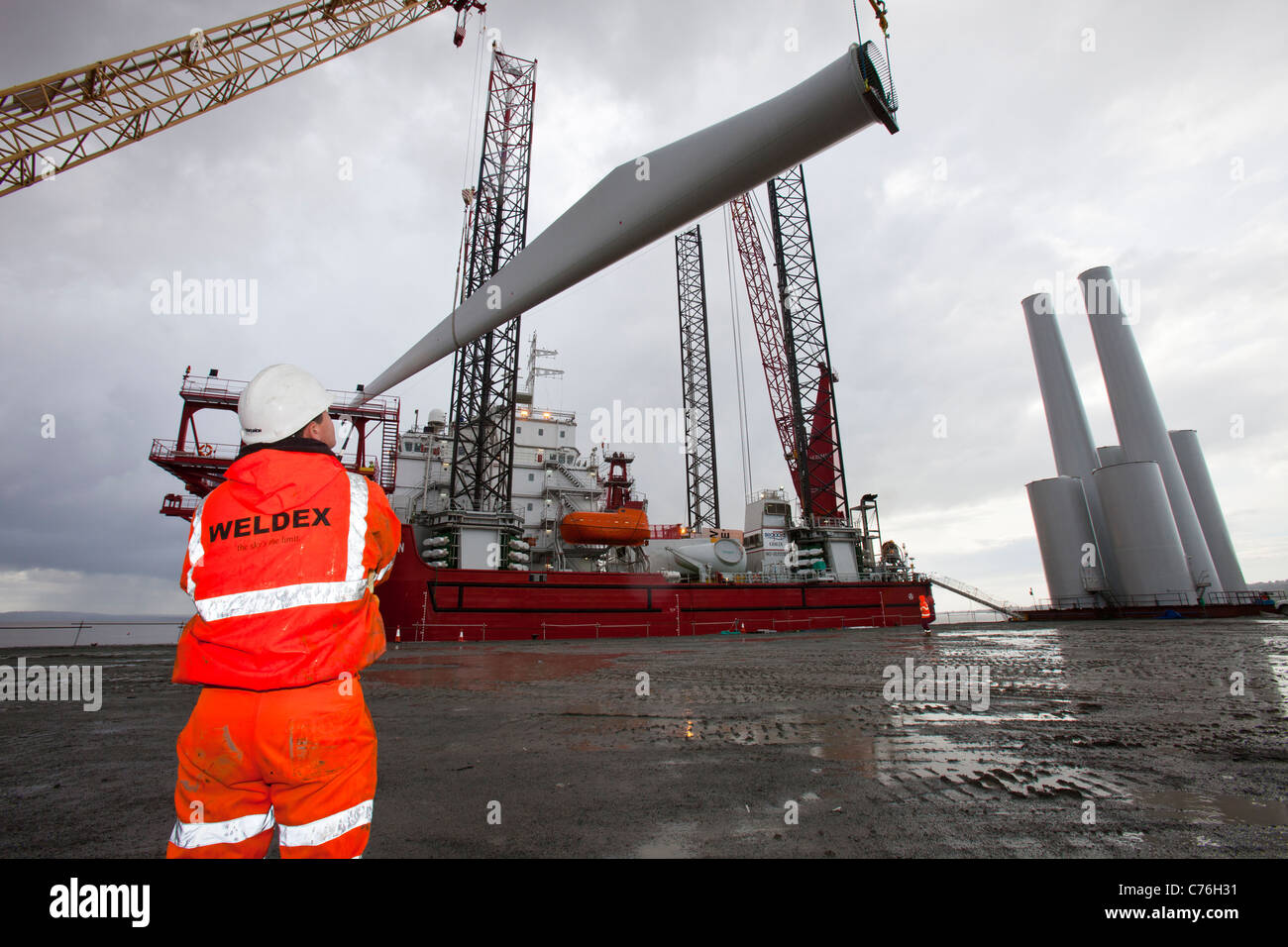 wind turbine blades being lifted onto a jack up barge, to construct the ...