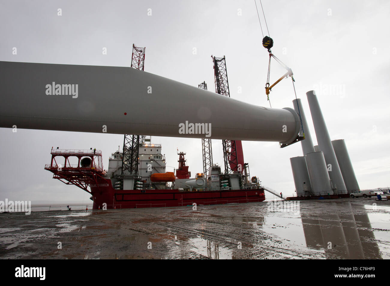 wind turbine blades being lifted onto a jack up barge, to construct the ...