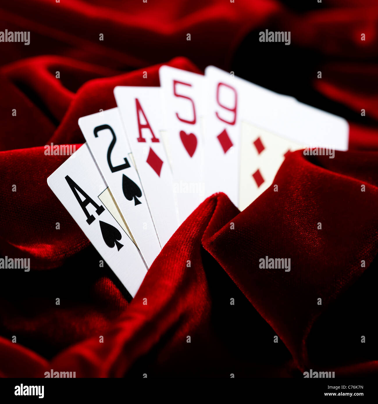 A hand of cards on luxurious red velvet Stock Photo - Alamy